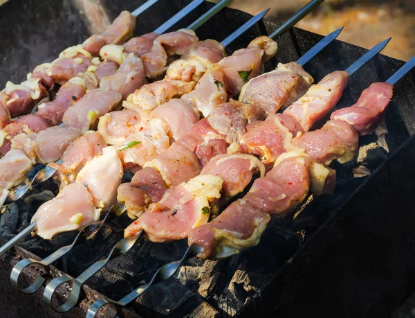 Many roast meat pieces on skewer. shish kebab cooking process - Stock Image - Everypixel
