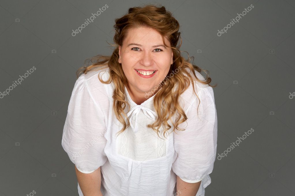 Smiling fat woman on gray background — Stock Photo © spaxiax #10770100
