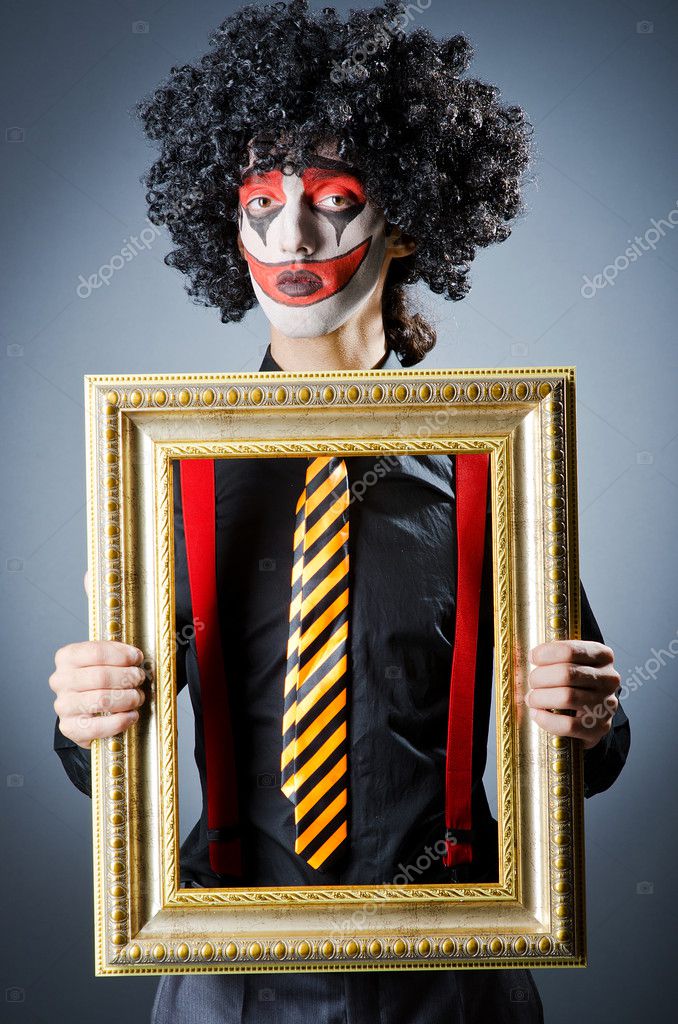 Clown with picture frames in studio — Stock Photo © Elnur_ #12322714