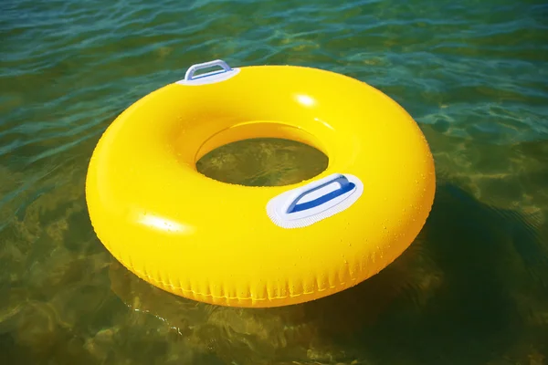 Yellow swim ring floating on a sea Stock Photo by ©Sergios 192027998