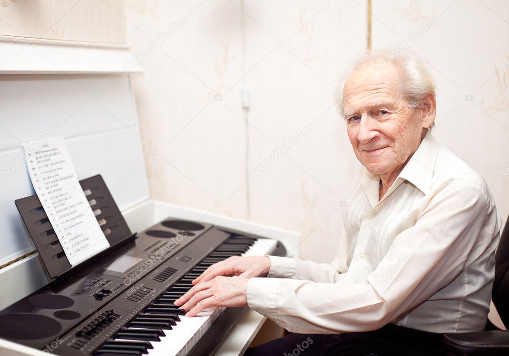 Pleased Senior Man Playing Piano — Stock Photo © Anita_Bonita #11524811