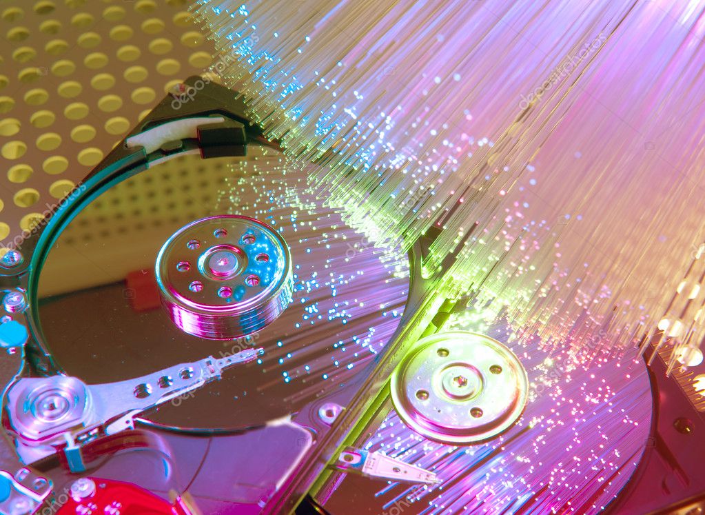Computer harddisk and heads on technology fiber optics background Stock ...