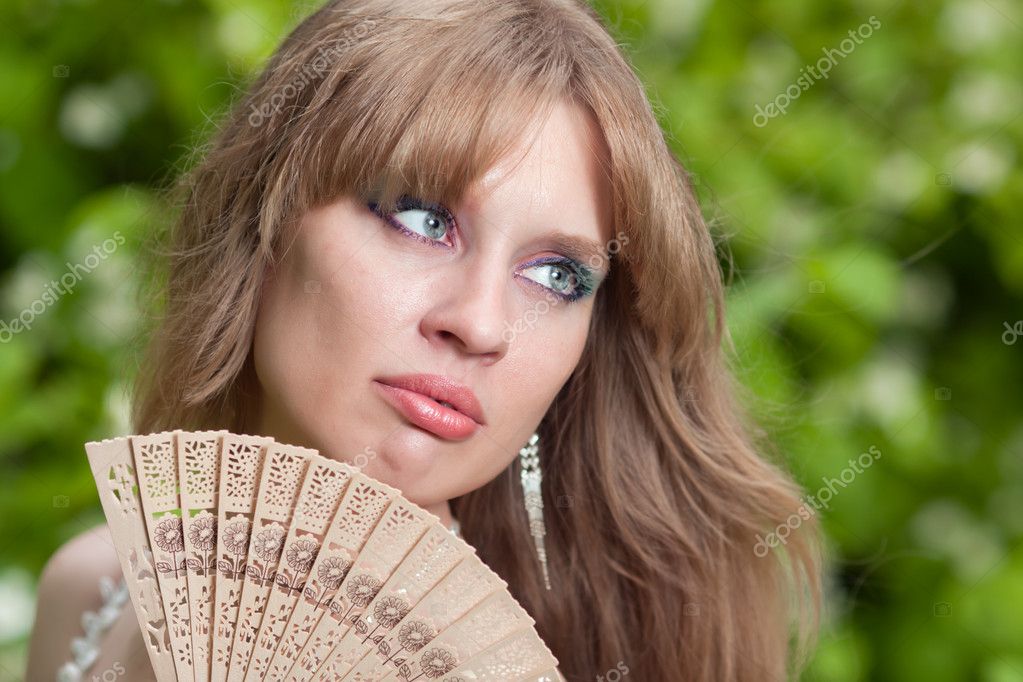 Girl's face and fan — Stock Photo © melektaus #11176280
