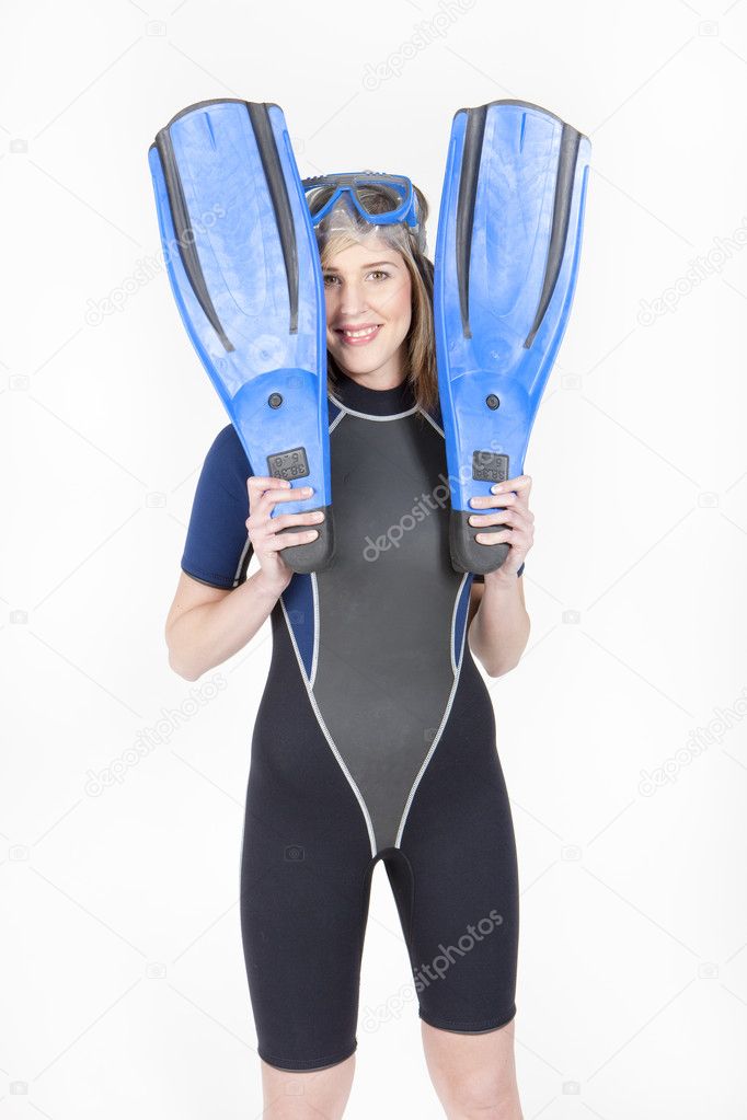 Standing young woman wearing neoprene with flippers and diving g ...