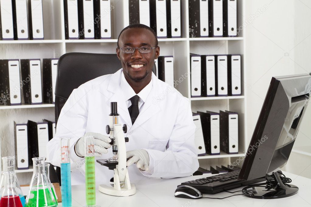 African american medical scientist with microscope in laboratory ...