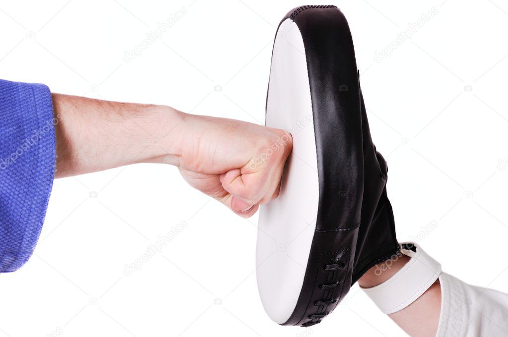 Karate kick with clenched fist on a white background Stock Photo by ...