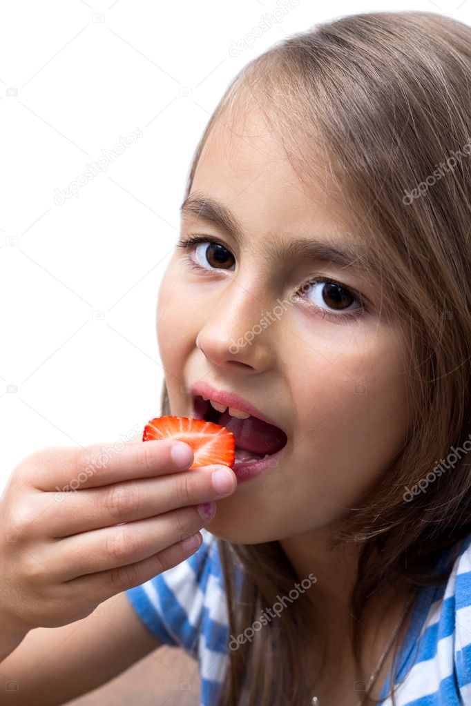 Happy little girl eats strawberries, isolated over white Stock Photo by ...