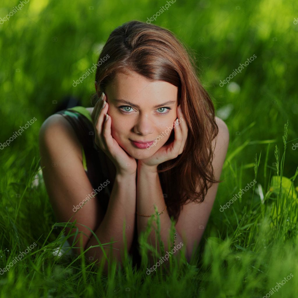 Beautiful woman laying on grass Stock Photo by ©yellow2j 10738991