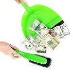Sweeps money in the shovel on wooden background close-up Stock Photo by ...