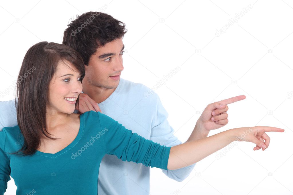 Couple stood together pointing into the distance — Stock Photo ...