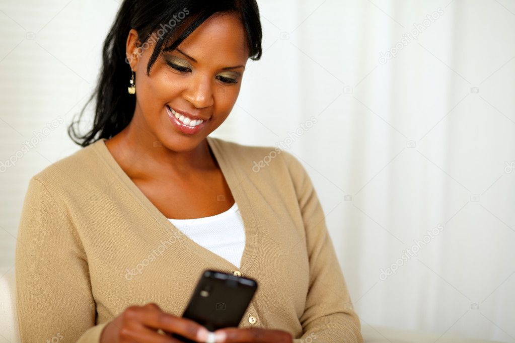 Friendly black woman sending a message Stock Photo by ©pablocalvog 11997206
