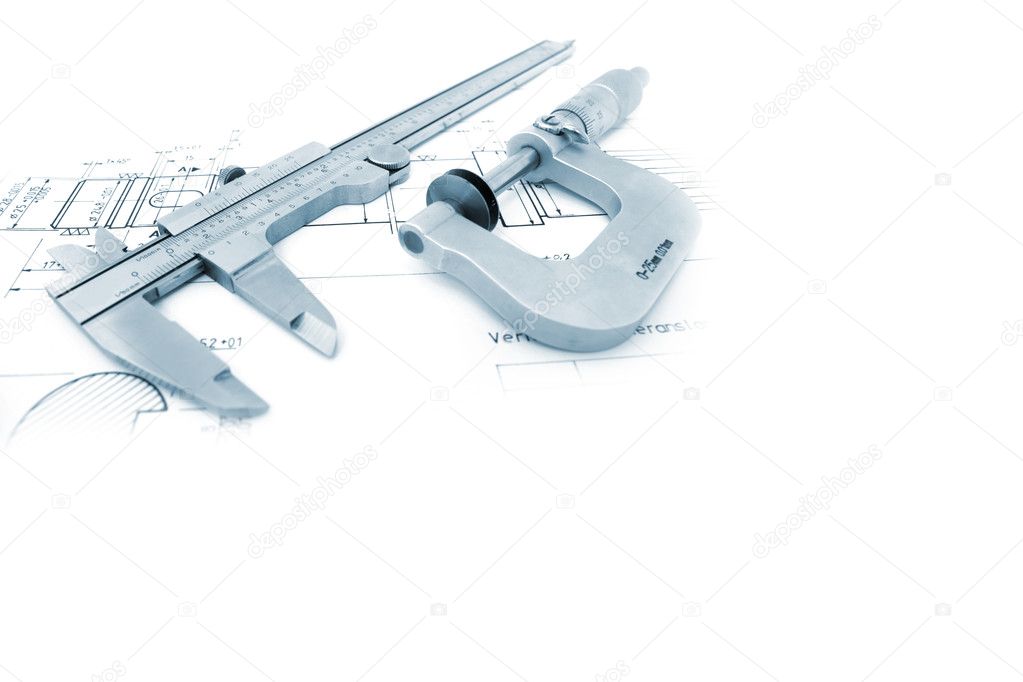 Caliper and Micrometer on blueprint horizontal close up with copyspace ...
