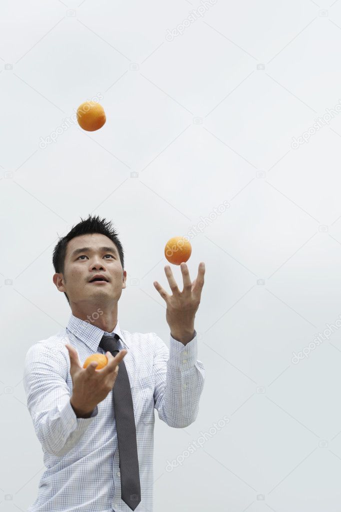 Asian Business man juggling — Stock Photo © sjenner13 #12003129