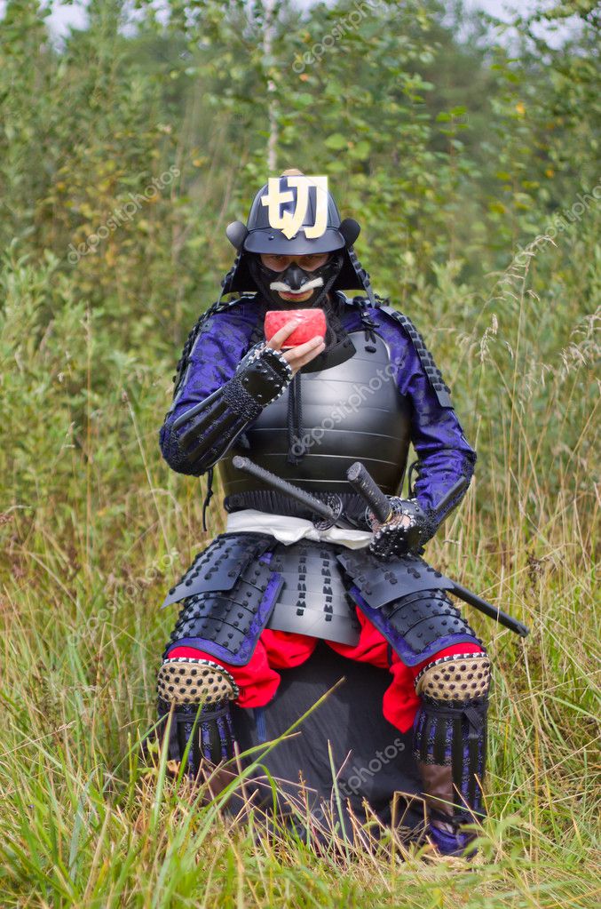 Samurai in armor drinking from bowl — Stock Photo © joymsk #12441610