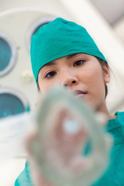 Serious nurse applying gas mask to a patient - Stock Image - Everypixel