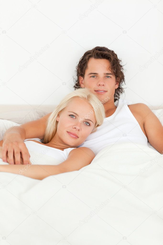 Cute couple lying on a bed — Stock Photo © Wavebreakmedia #11184255 Cute couple lying on a bed — Stock Photo © Wavebreakmedia #11184255