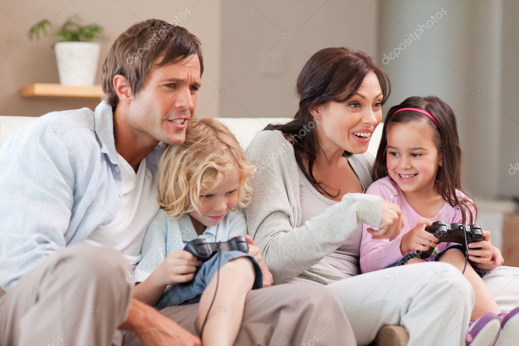 Competitive family playing video games together — Stock Photo ...
