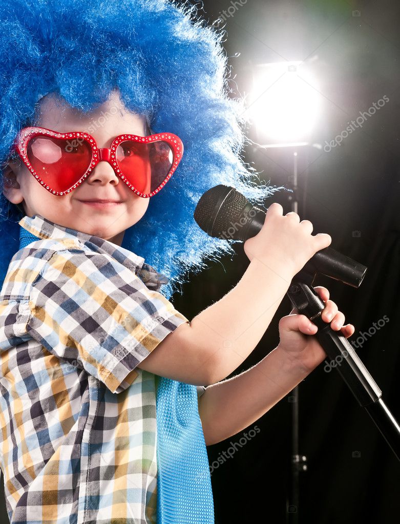 Boy sings into a microphone Stock Photo by ©lexmomot 11456732