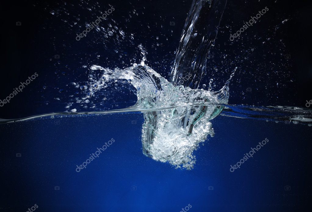Pouring water. Splash image on a blue background Stock Photo by ...