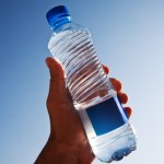 Human hand holding a bottle of water — Stock Photo © nejron #1741161