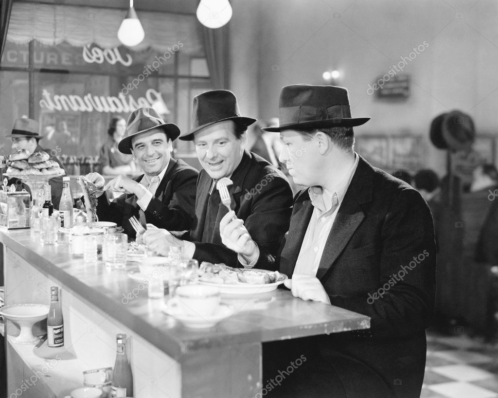 Three men sitting at the counter of a diner — Stock Photo © everett225 ...